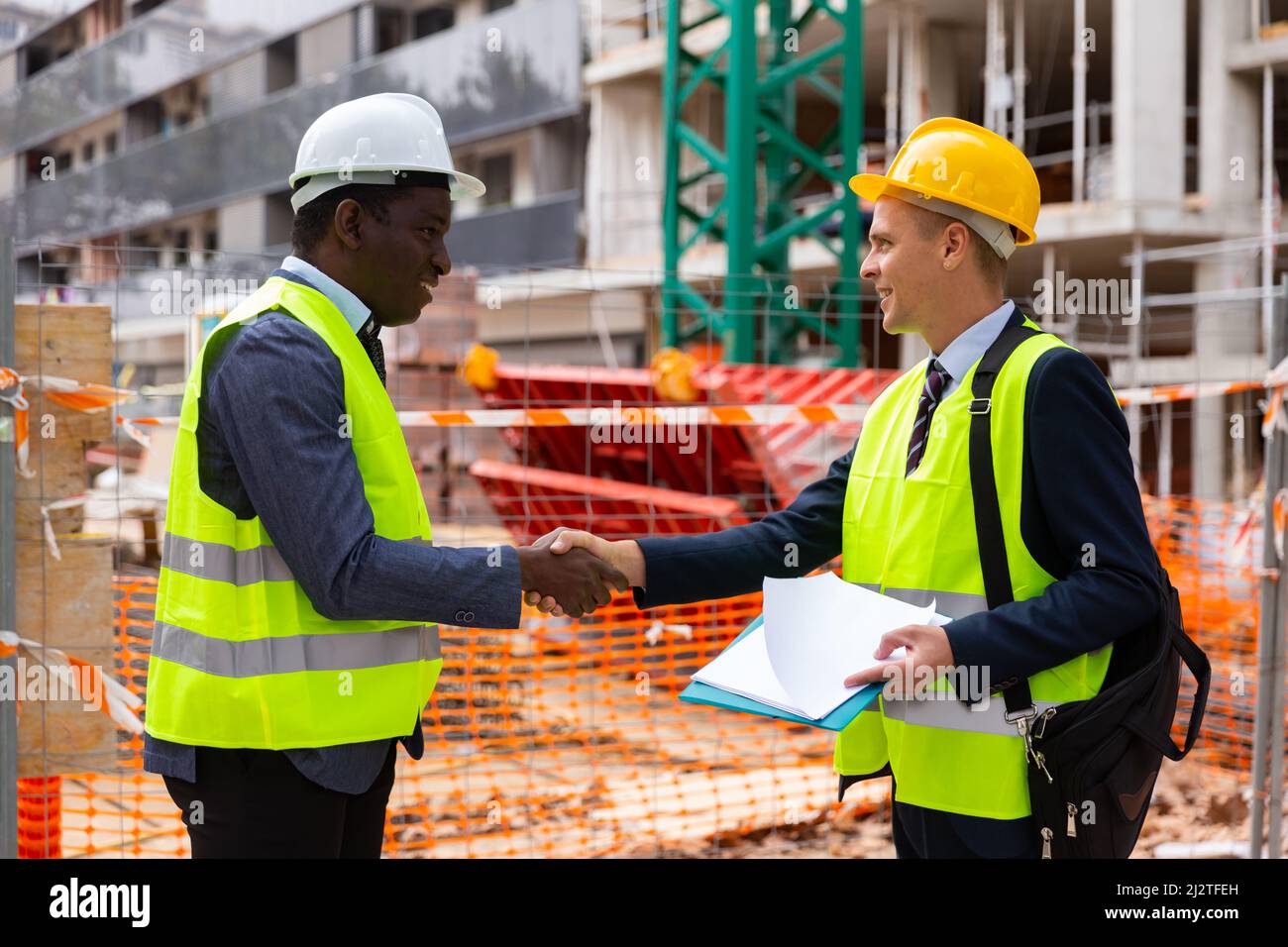 Two successful civil engineers exchange a friendly handshake Stock ...