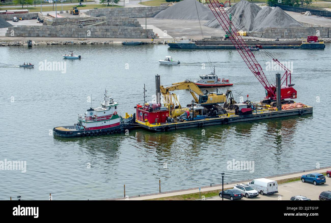 June 19 2021 St Joseph MI USA; A tug boat pulls a construction barge ...