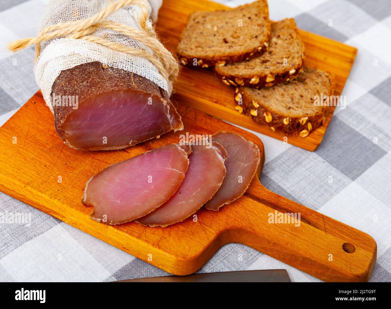 Sliced cured pork sirloin meat with bread Stock Photo - Alamy