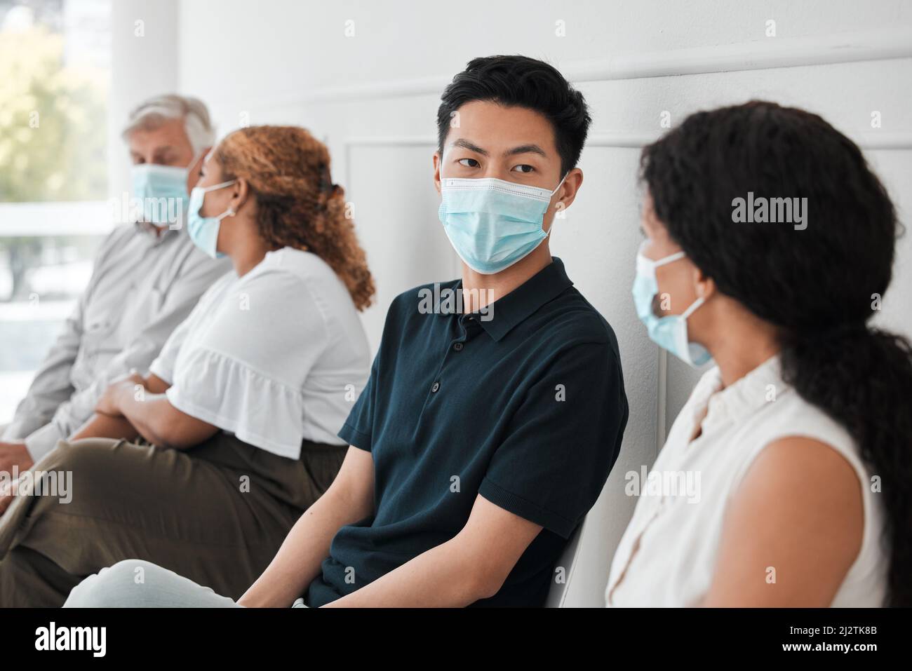 Adhering to protocol for the safety of all. Shot of a group of people ...