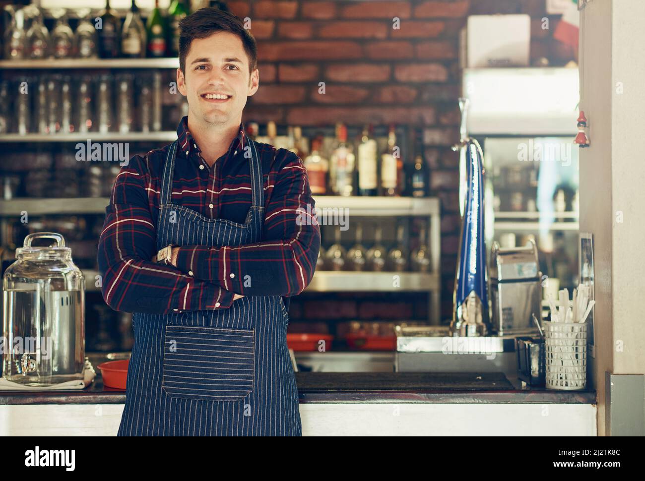 Running his restaurant like a boss. Portrait of a smiling young ...