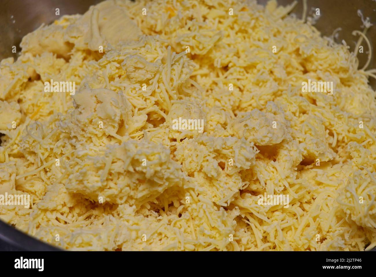 grated cheese making with electric grater machine Stock Photo - Alamy