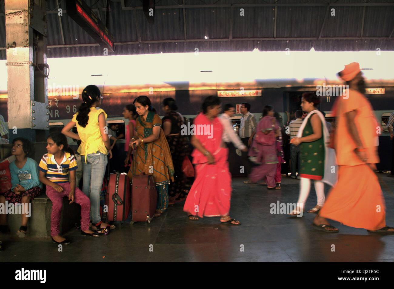 Train passengers waiting for departure time at the passenger platform ...