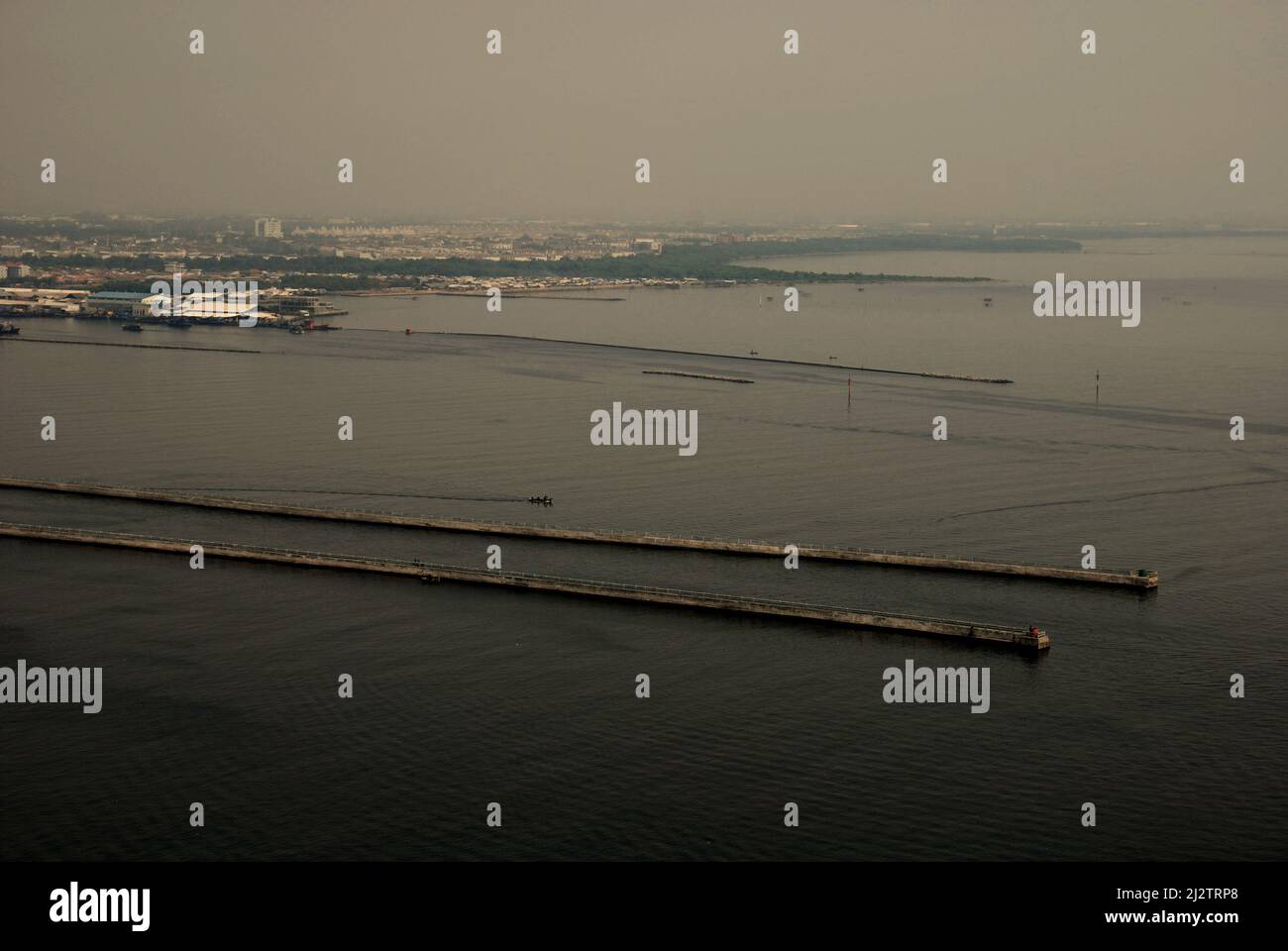 Aerial view of Jakarta coastline with Muara Angke fishing port and ...