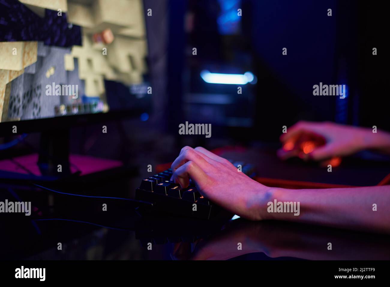 Professional gamer play computer video game in dark room, use neon ...