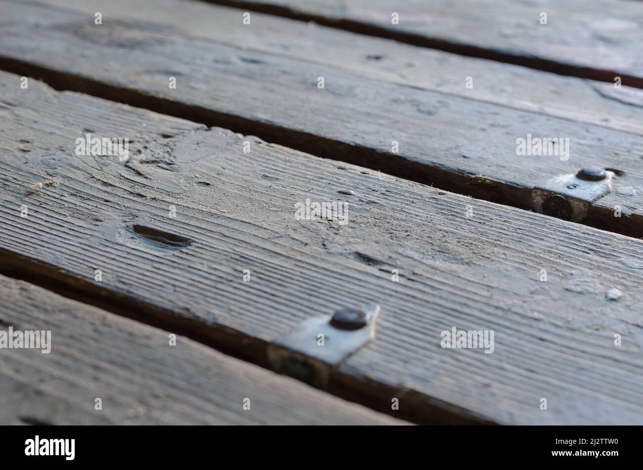 A defocused shot of the old floorboards. Dirty rectangular repeating ...
