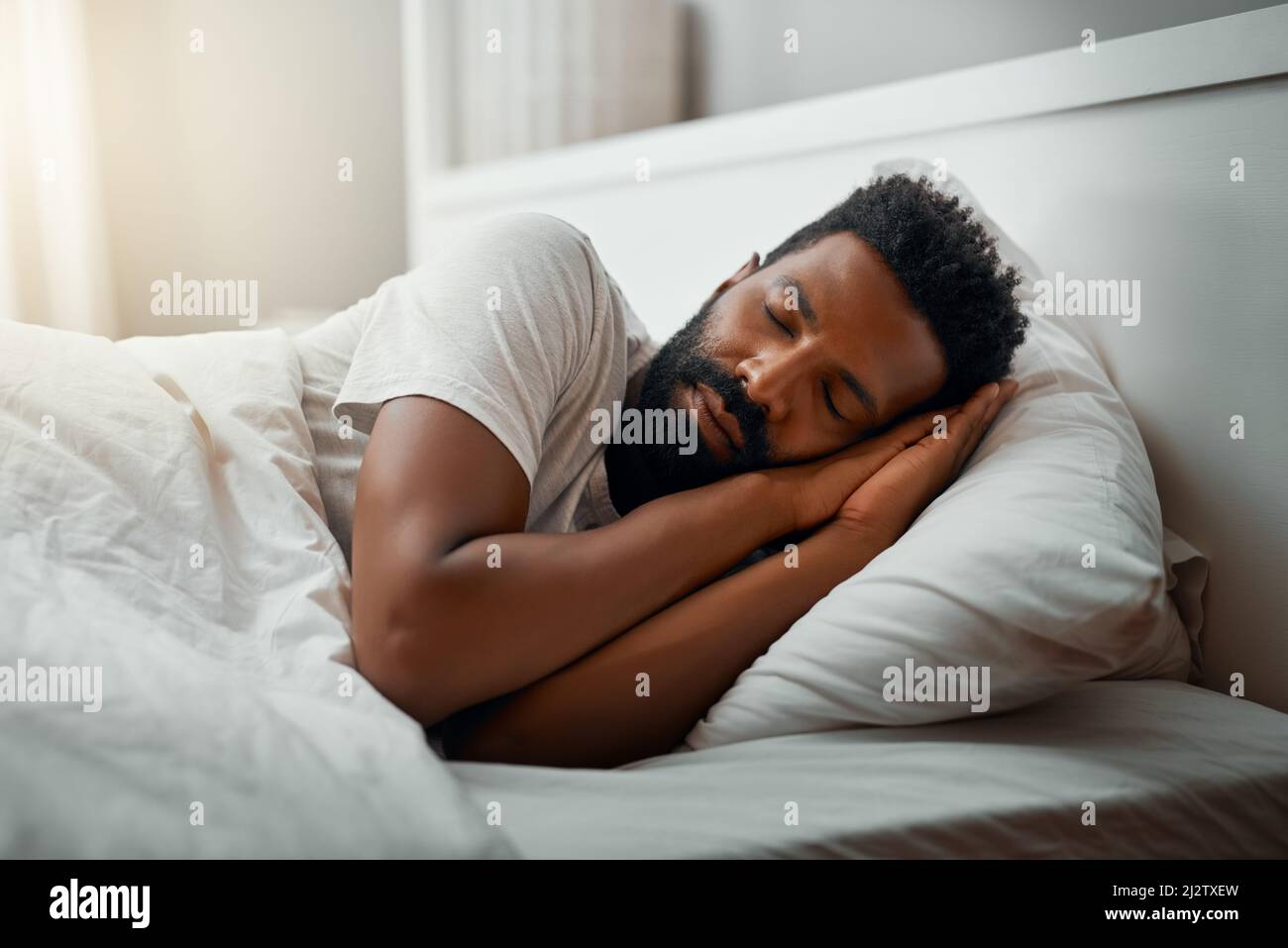 Sleeping in over the weekend. Cropped shot of a handsome young man ...