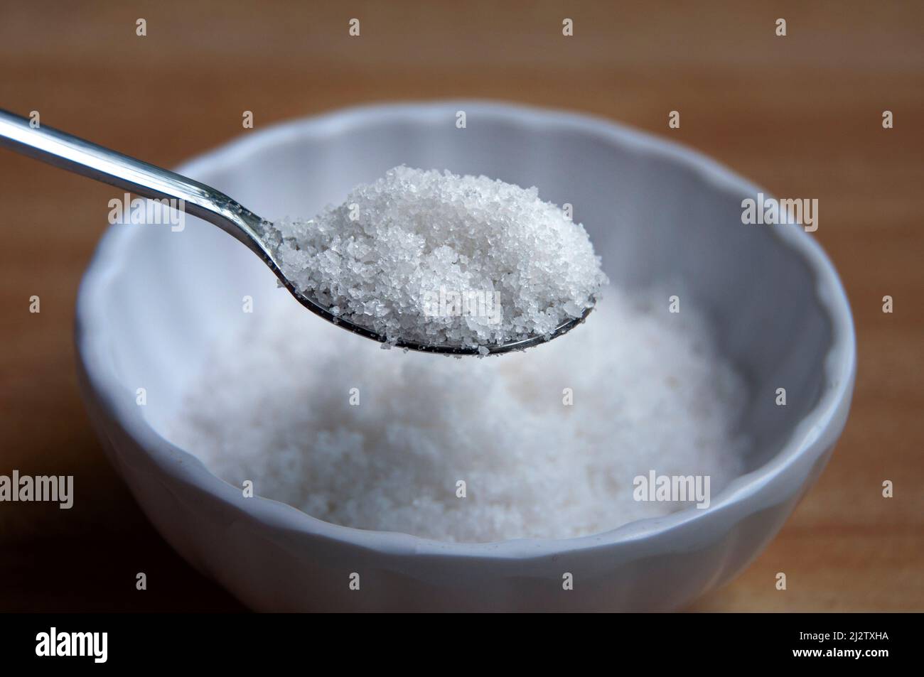 Close up of salt intake with spoon. Copy space and healthy food concept ...