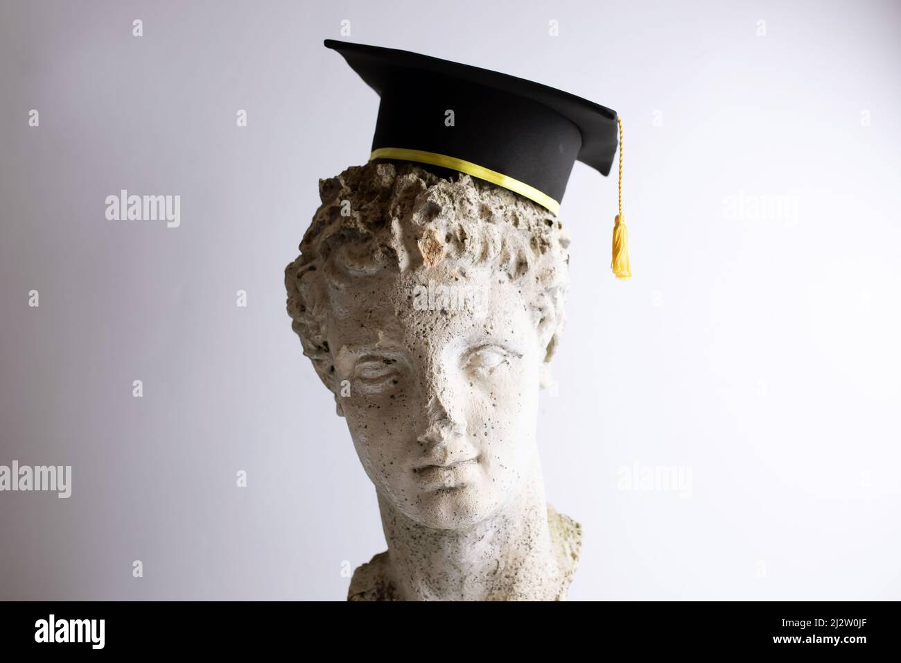 Antique gypsum statue with mortarboard. Education, graduation and ...