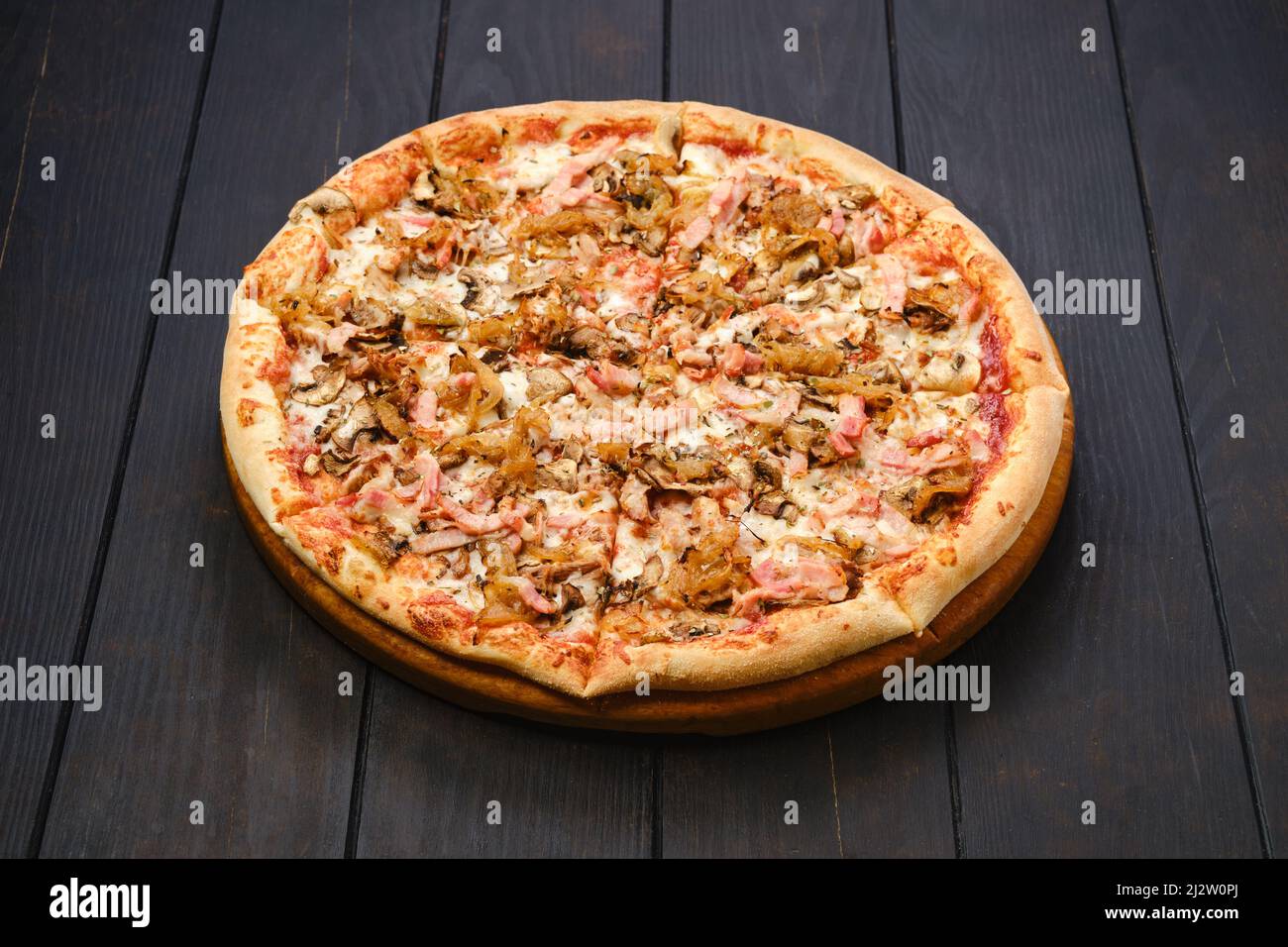 Pizza with bacon, ham, champignon and fried onion Stock Photo - Alamy
