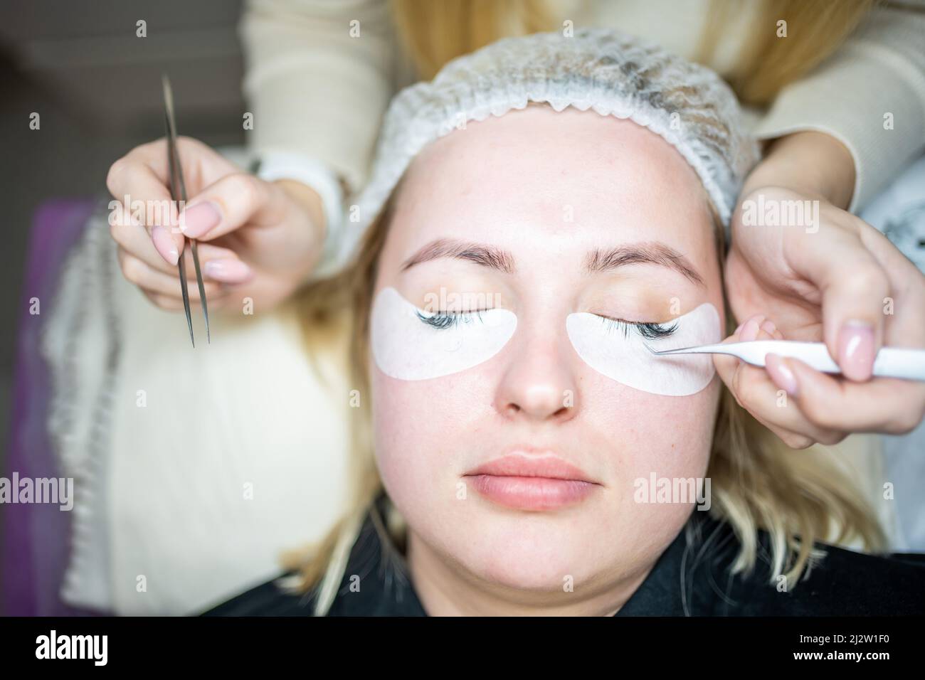 Eyelash extension procedure in beauty salon. Lashes close up. Concept ...