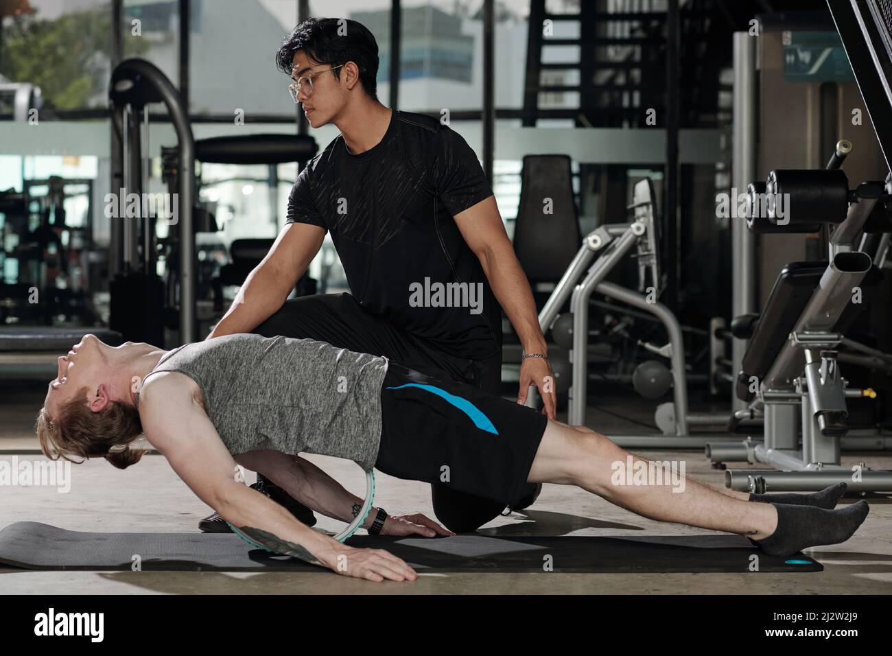 Man doing exercise assisted hi-res stock photography and images - Alamy