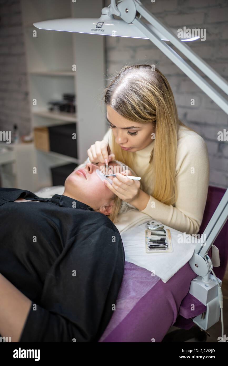 Eyelash extension procedure in beauty salon. Lashes close up. Concept ...