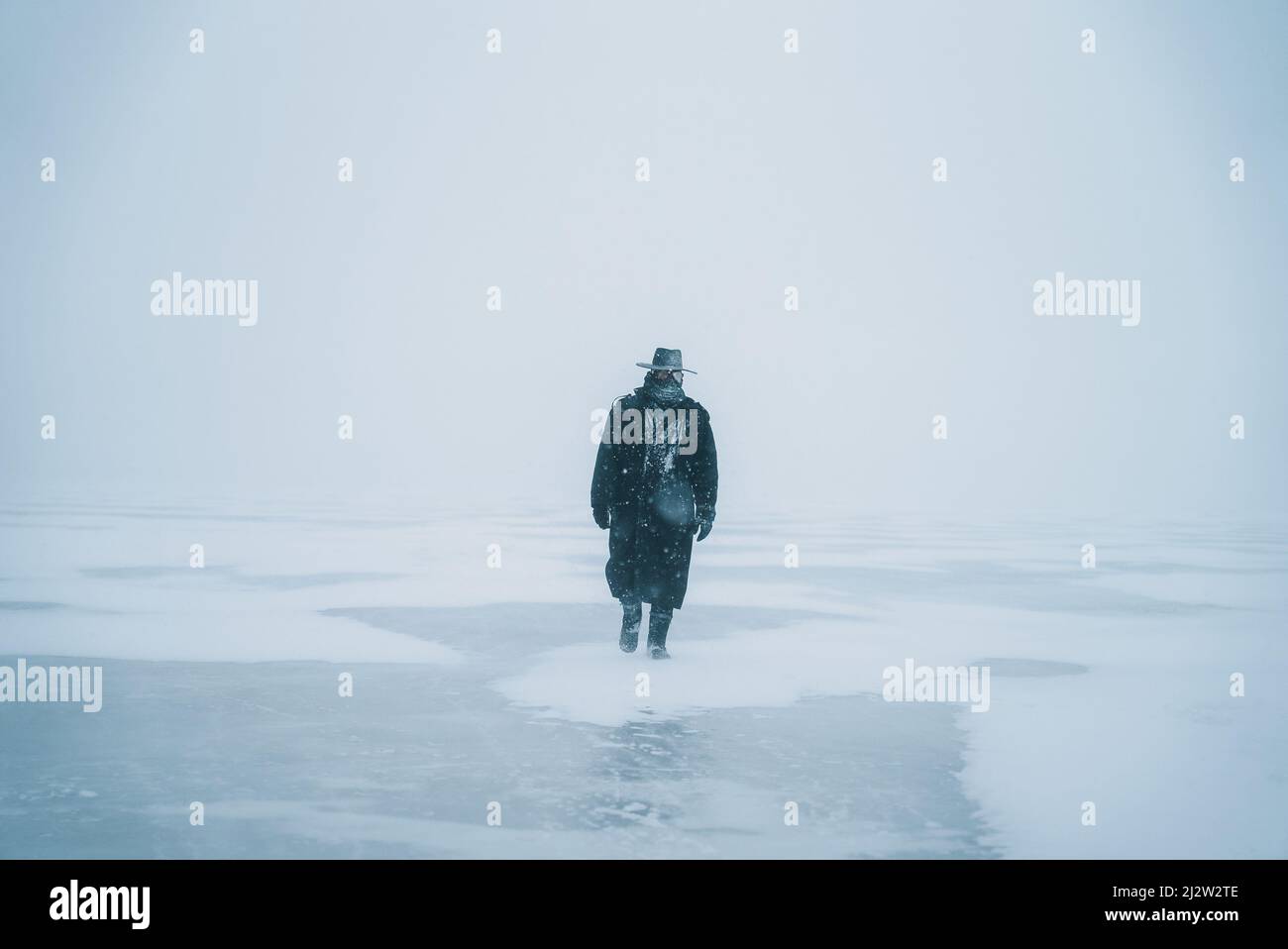 Man walking alone on ice, snow Stock Photo - Alamy