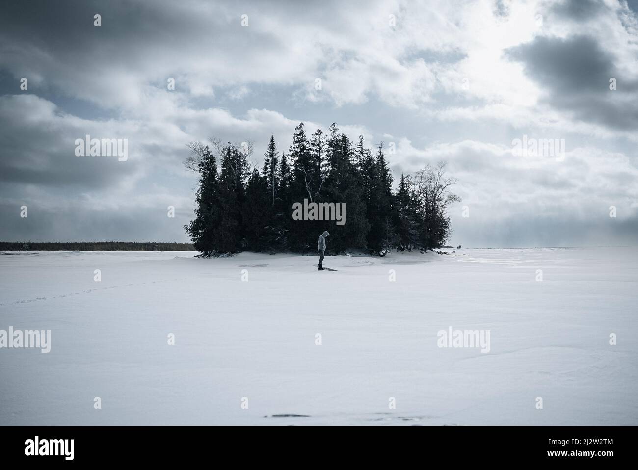 Man walking alone on ice, snow Stock Photo - Alamy