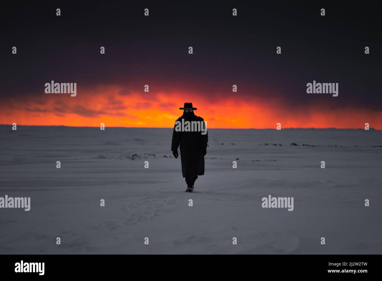 Man walking alone on ice, snow Stock Photo - Alamy