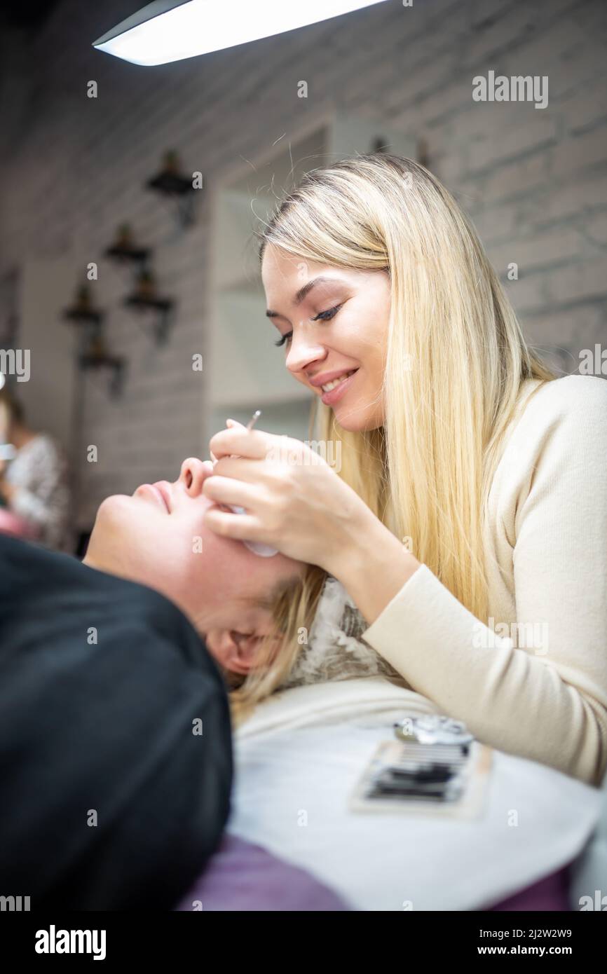 Eyelash extension procedure in beauty salon. Lashes close up. Concept ...