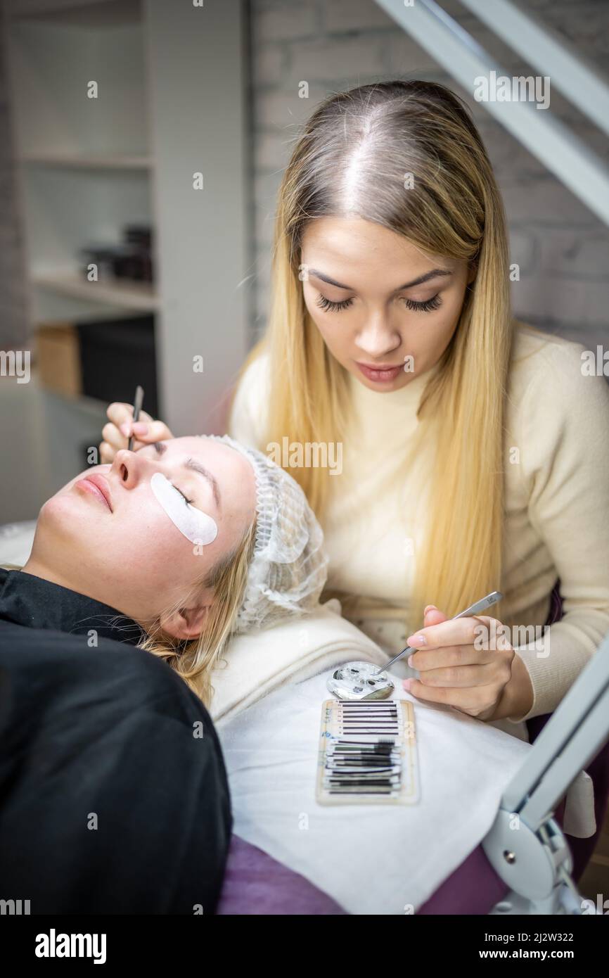 Eyelash extension procedure in beauty salon. Lashes close up. Concept ...