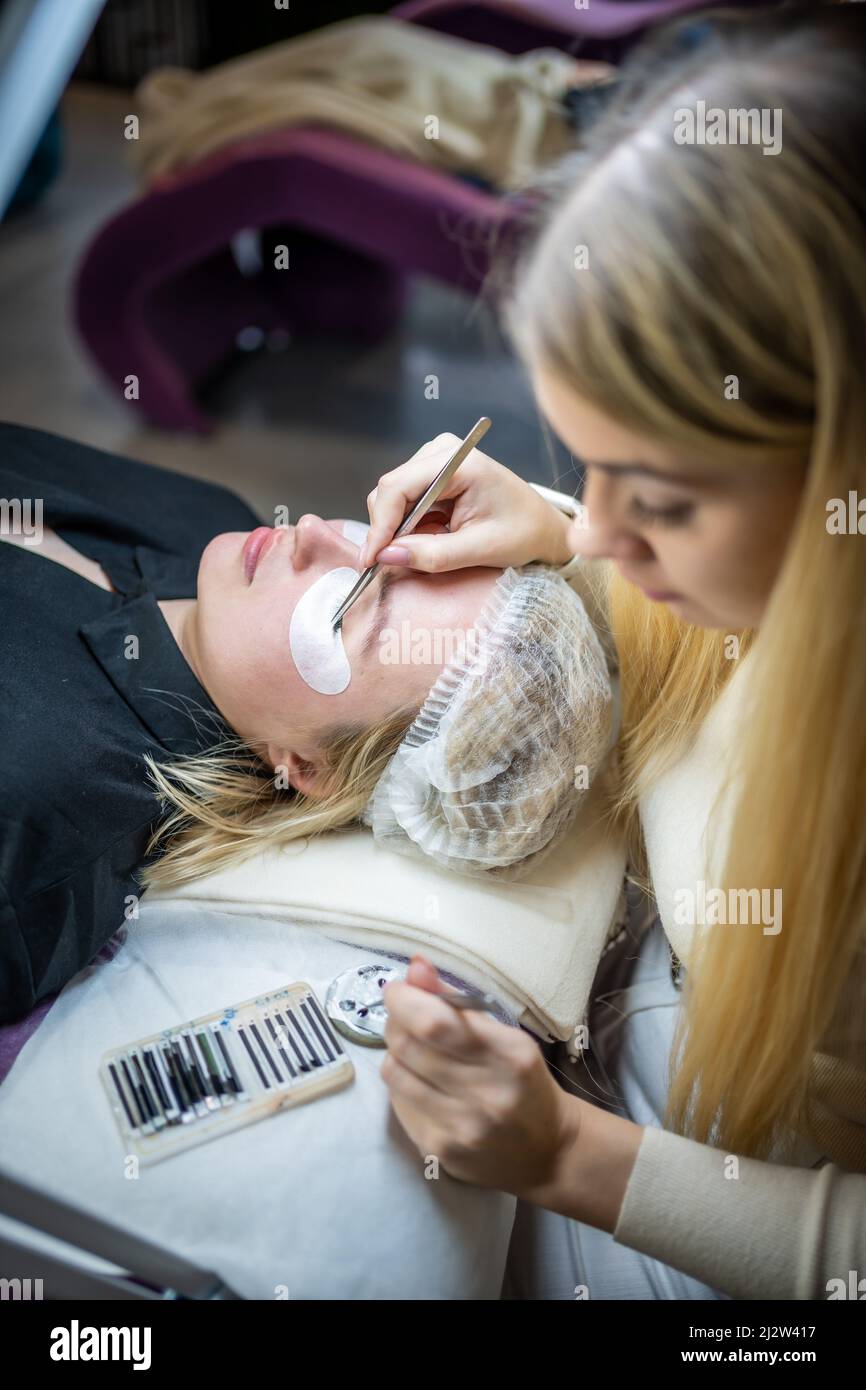 Eyelash extension procedure in beauty salon. Lashes close up. Concept ...