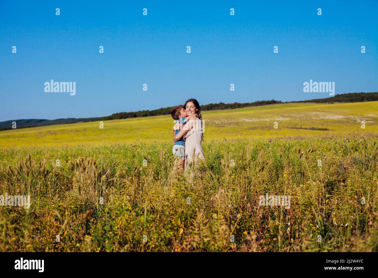 mother and son hugging in the field on a walk Stock Photo - Alamy