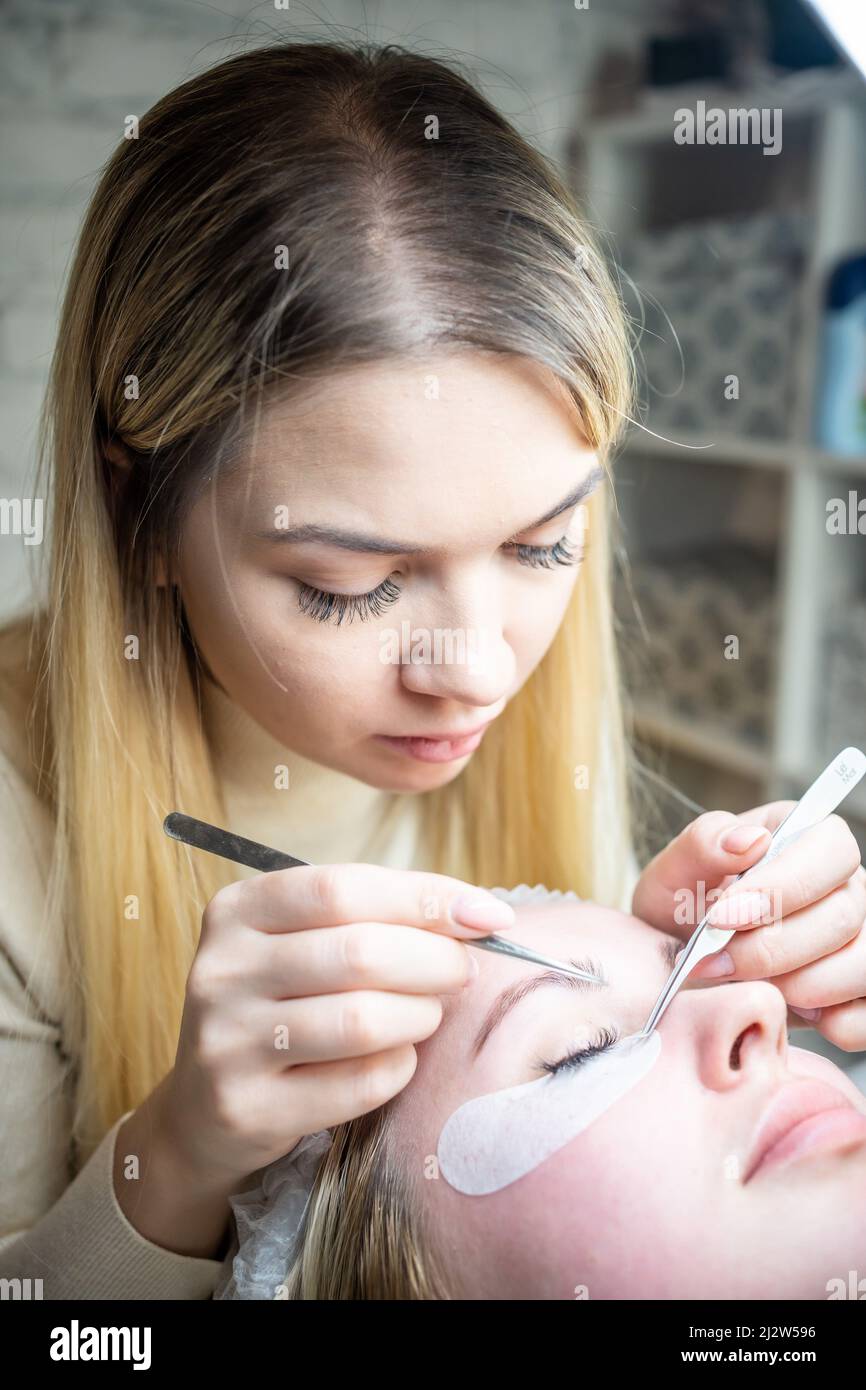 Eyelash extension procedure in beauty salon. Lashes close up. Concept ...