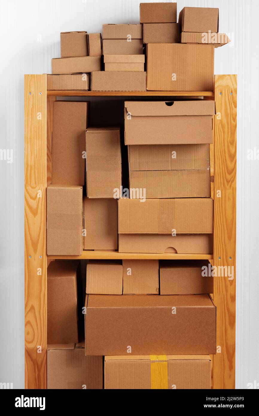 Stack of cardboard package boxes on wooden rack Stock Photo - Alamy