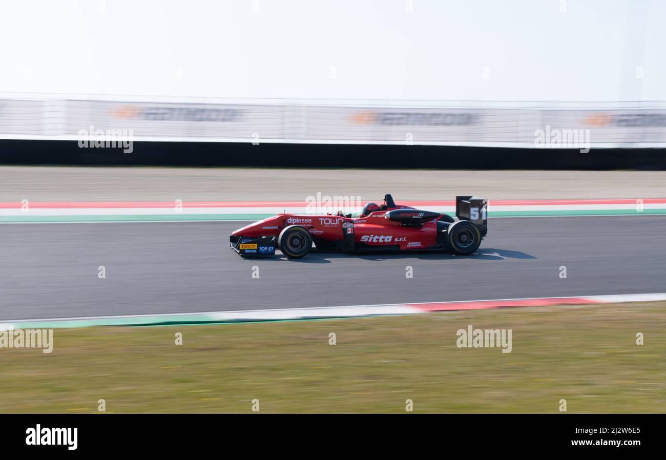 Racing car single seater speed action on asphalt racetrack with light ...