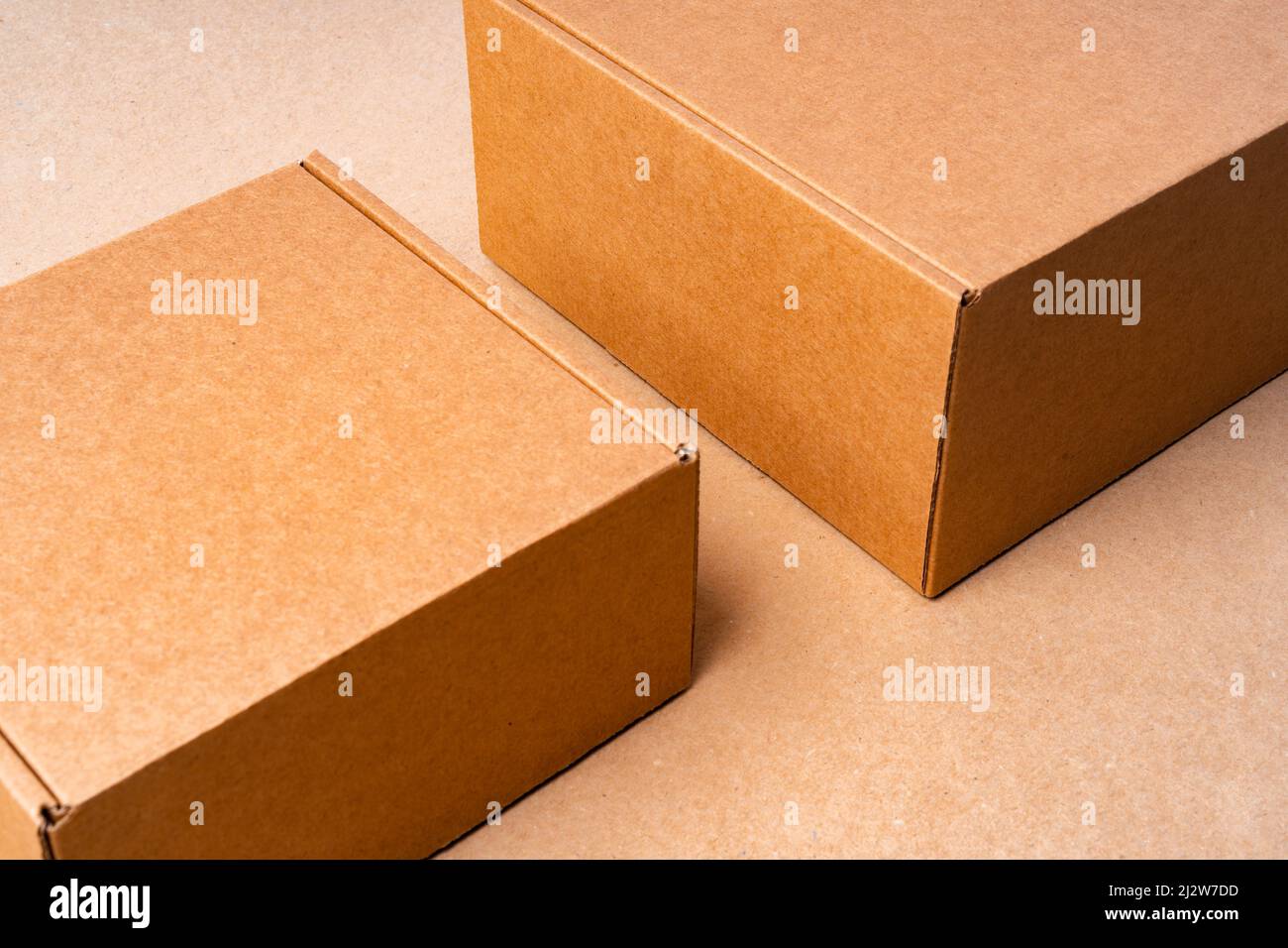 Cardboard box on beige background in studio Stock Photo - Alamy