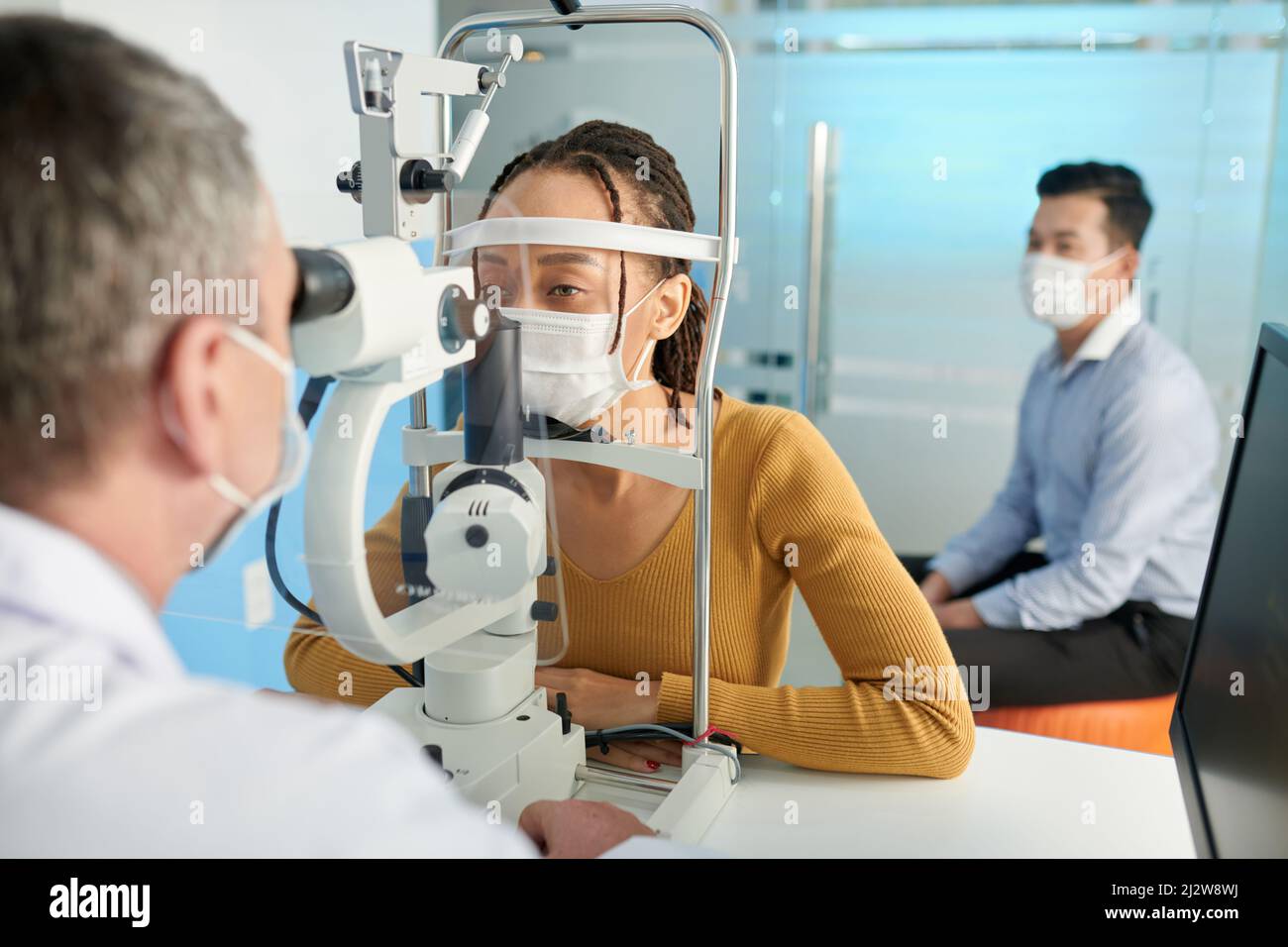 Young woman getting intraocular pressure measured in medical office of ...