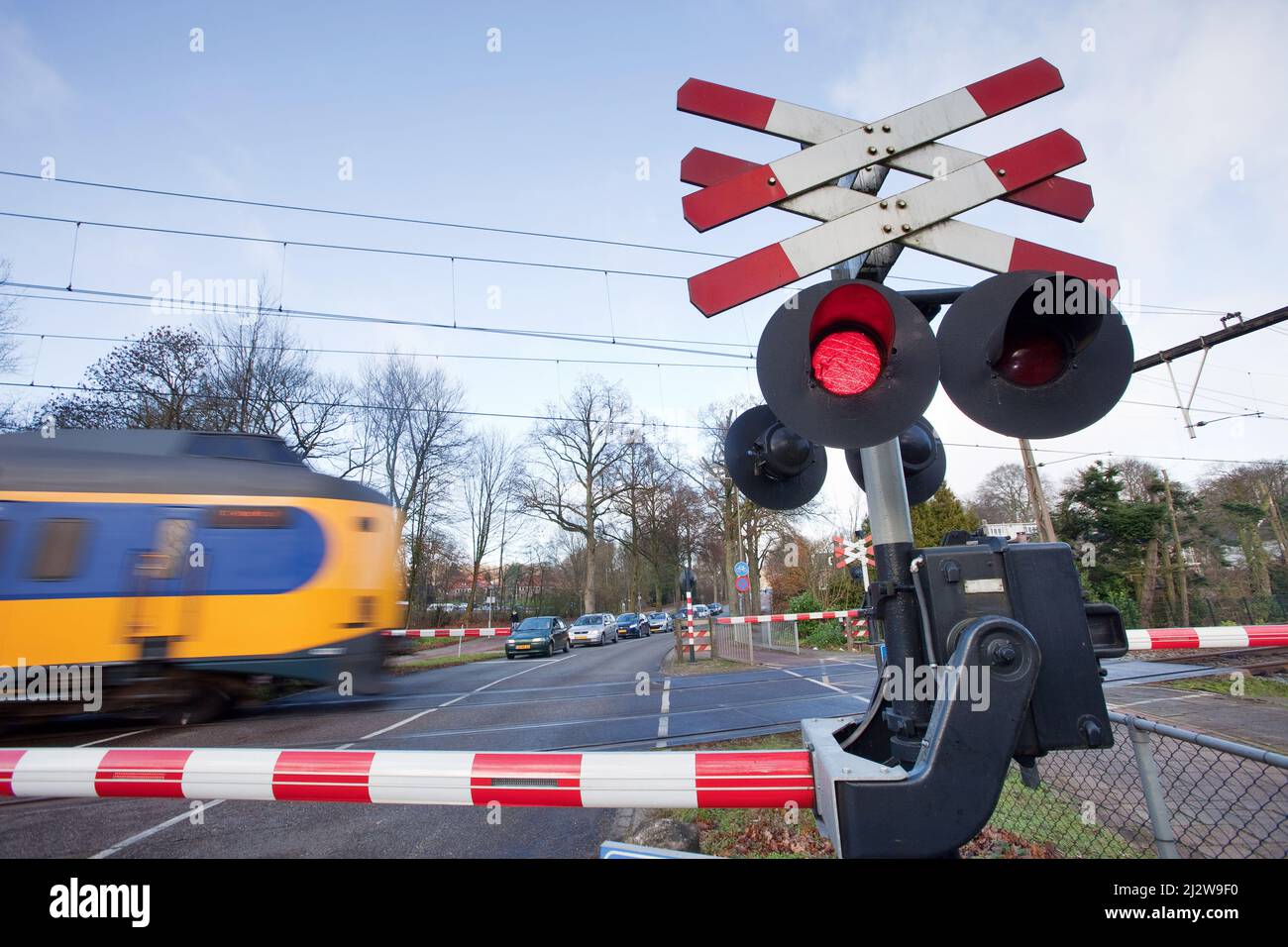 Netherlands, train passes a level crossing in Arnhem with crossbucks ...