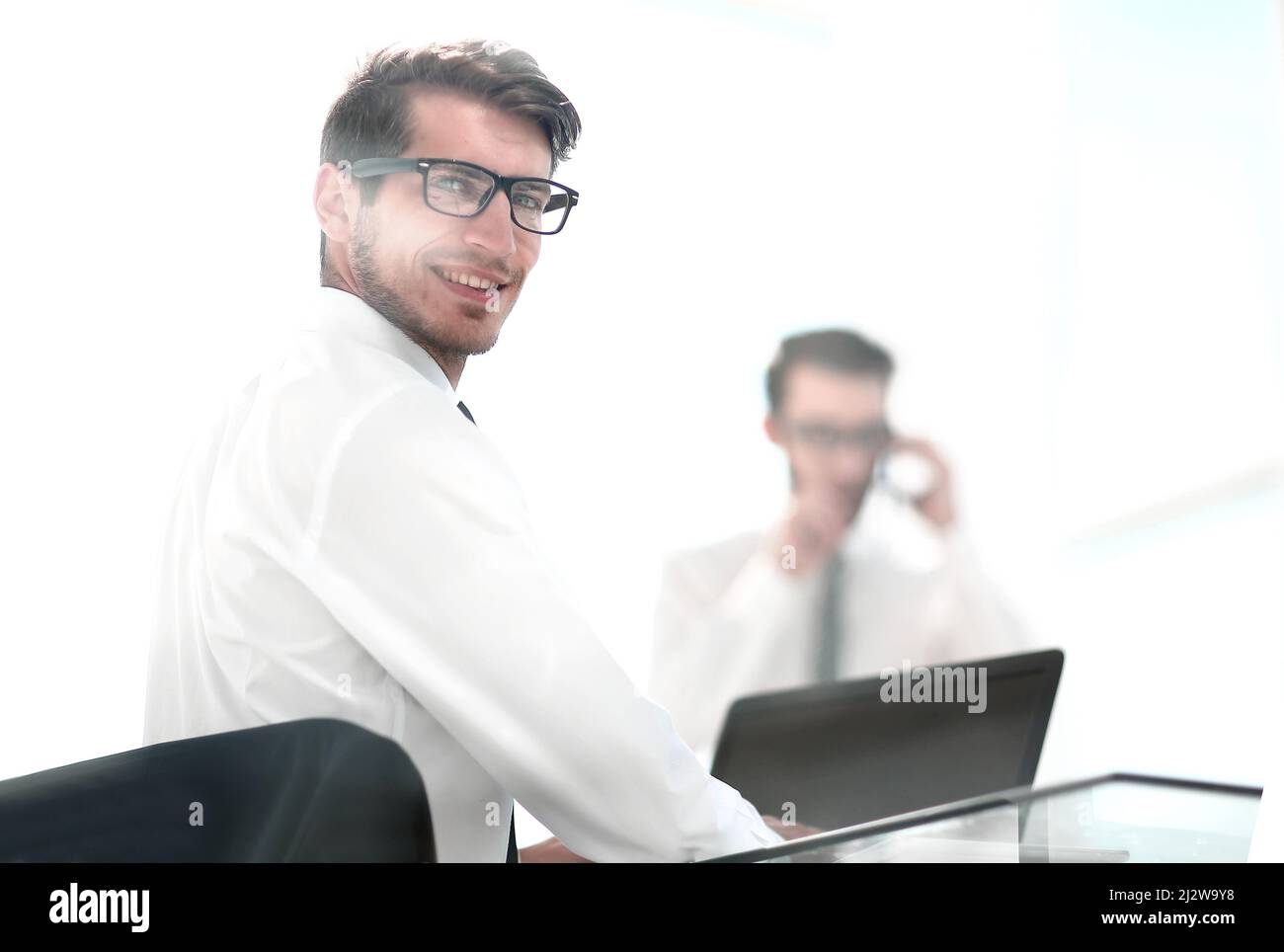 rear view.employees sitting at the office Desk Stock Photo - Alamy