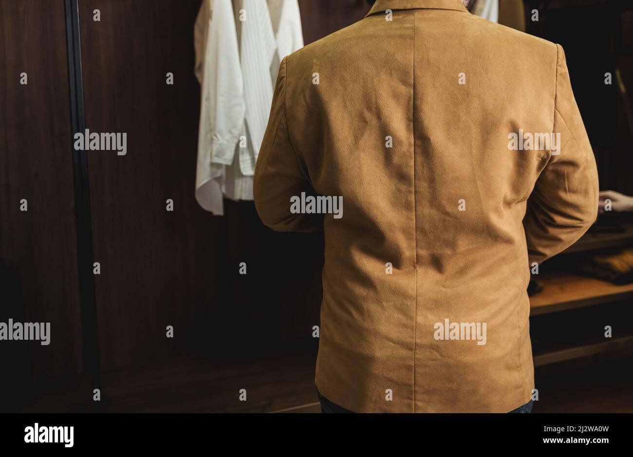 back view of a man in suit standing in room. men's fashion Stock Photo ...