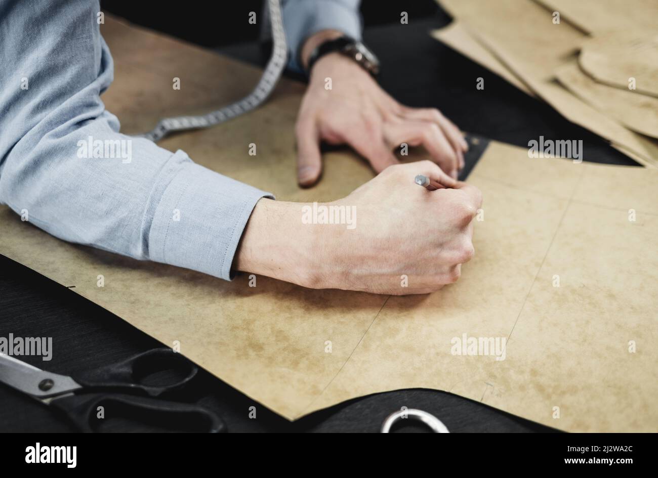 tailor working with sewing pattern in atelier Stock Photo - Alamy