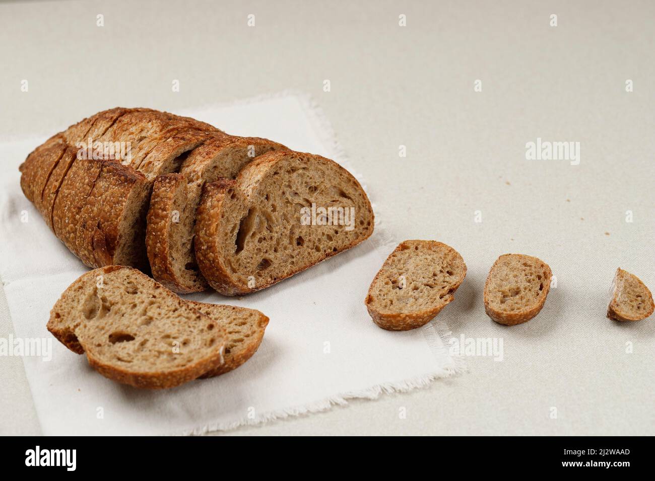 Bread, Traditional Sourdough Bread Cut into Slices on a cCeam ...