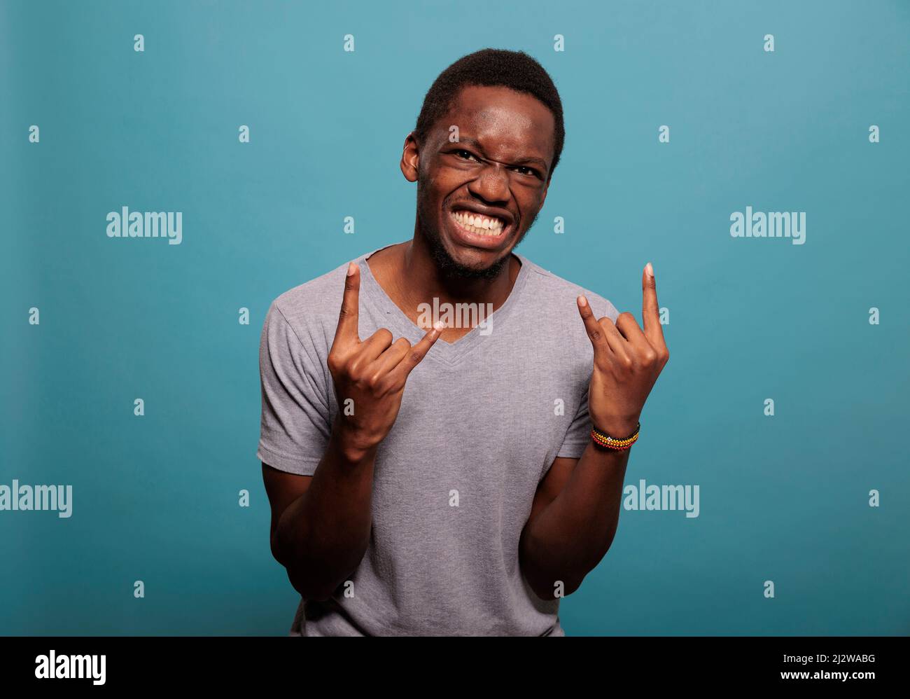 Funky person advertising rock and roll symbol with fingers in front of ...