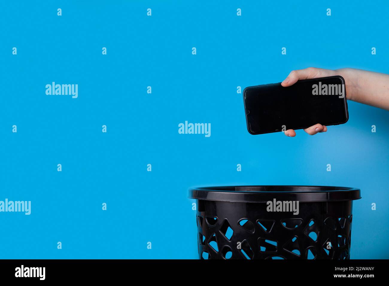The smartphone is thrown into the trash for disposal and recycling ...