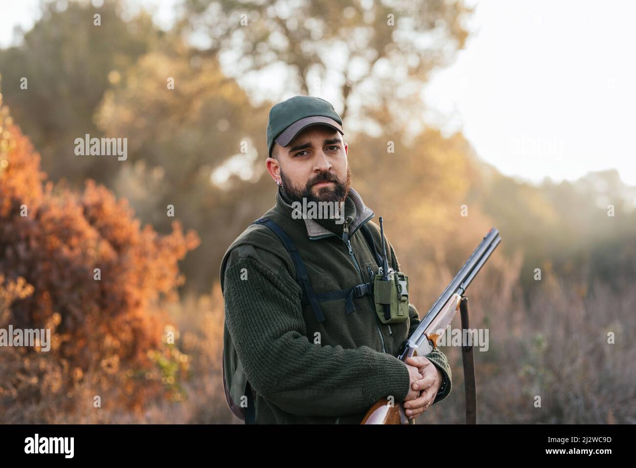 Hunter posing while holding his shotgun and looking at camera Stock ...
