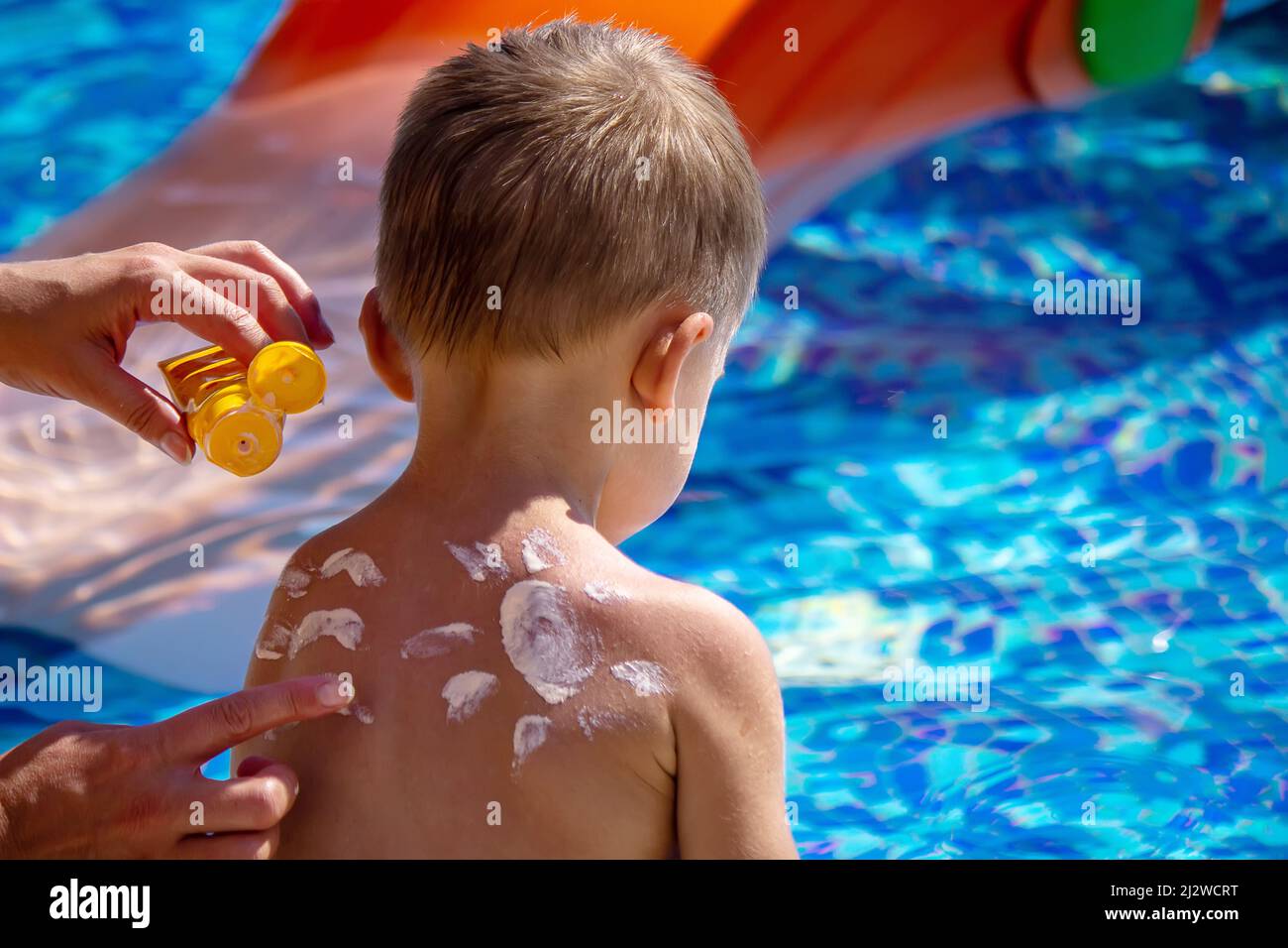 Mother applying suntan lotion son hi-res stock photography and images ...