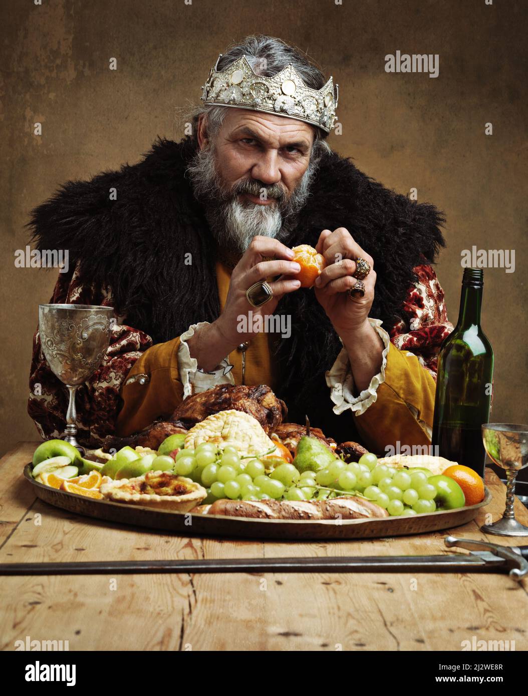 Its good to be the king. A mature king feasting alone in a banquet hall ...