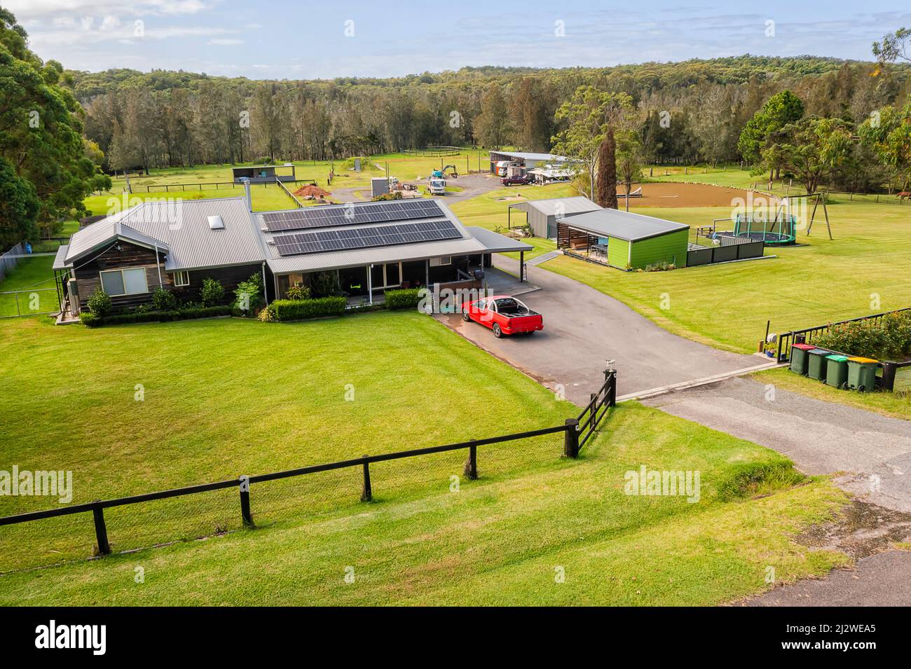 Remote rural agriculture farm with horse stable on green lawn pastures ...