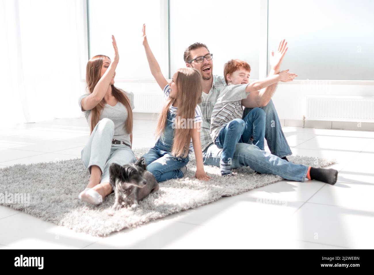 happy family with kids giving each other a high five Stock Photo - Alamy