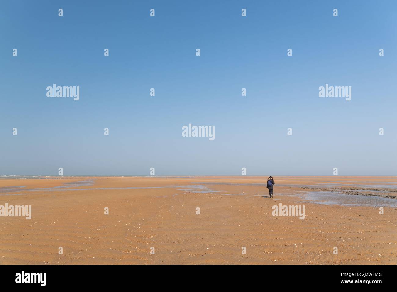 One person walking in an empty beach Stock Photo - Alamy
