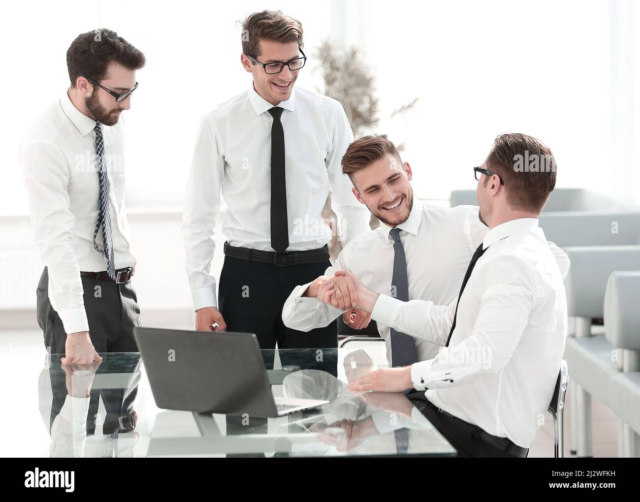 happy employees shaking hands Stock Photo - Alamy