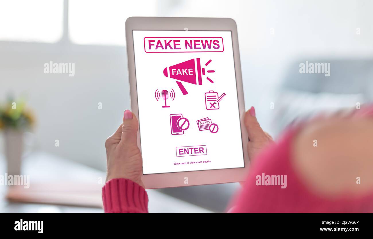 Tablet screen displaying a fake news concept Stock Photo - Alamy