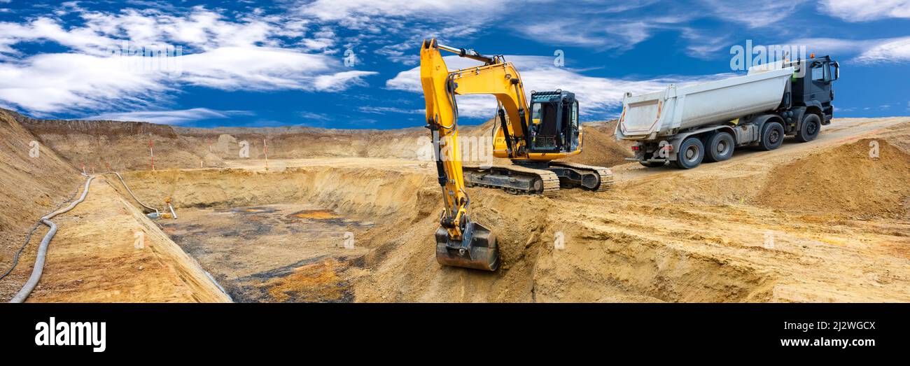 heavy excavator working on construction site Stock Photo - Alamy