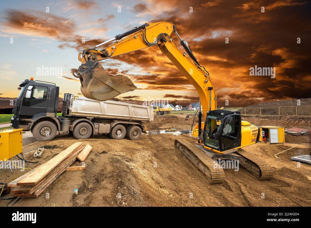 heavy excavator working on construction site Stock Photo - Alamy