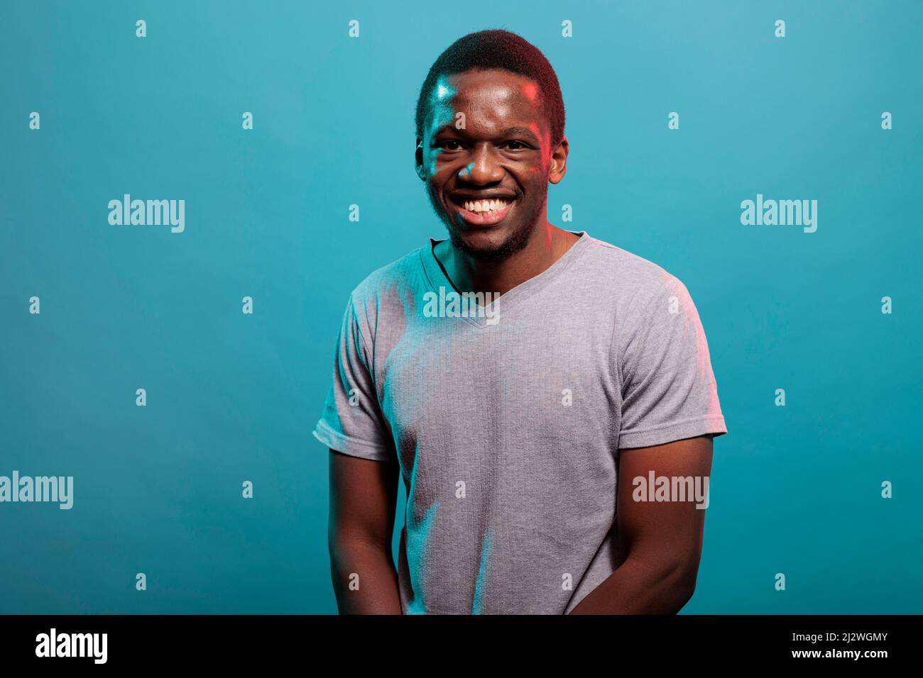 Portrait of happy adult smiling in front of camera, showing positive ...