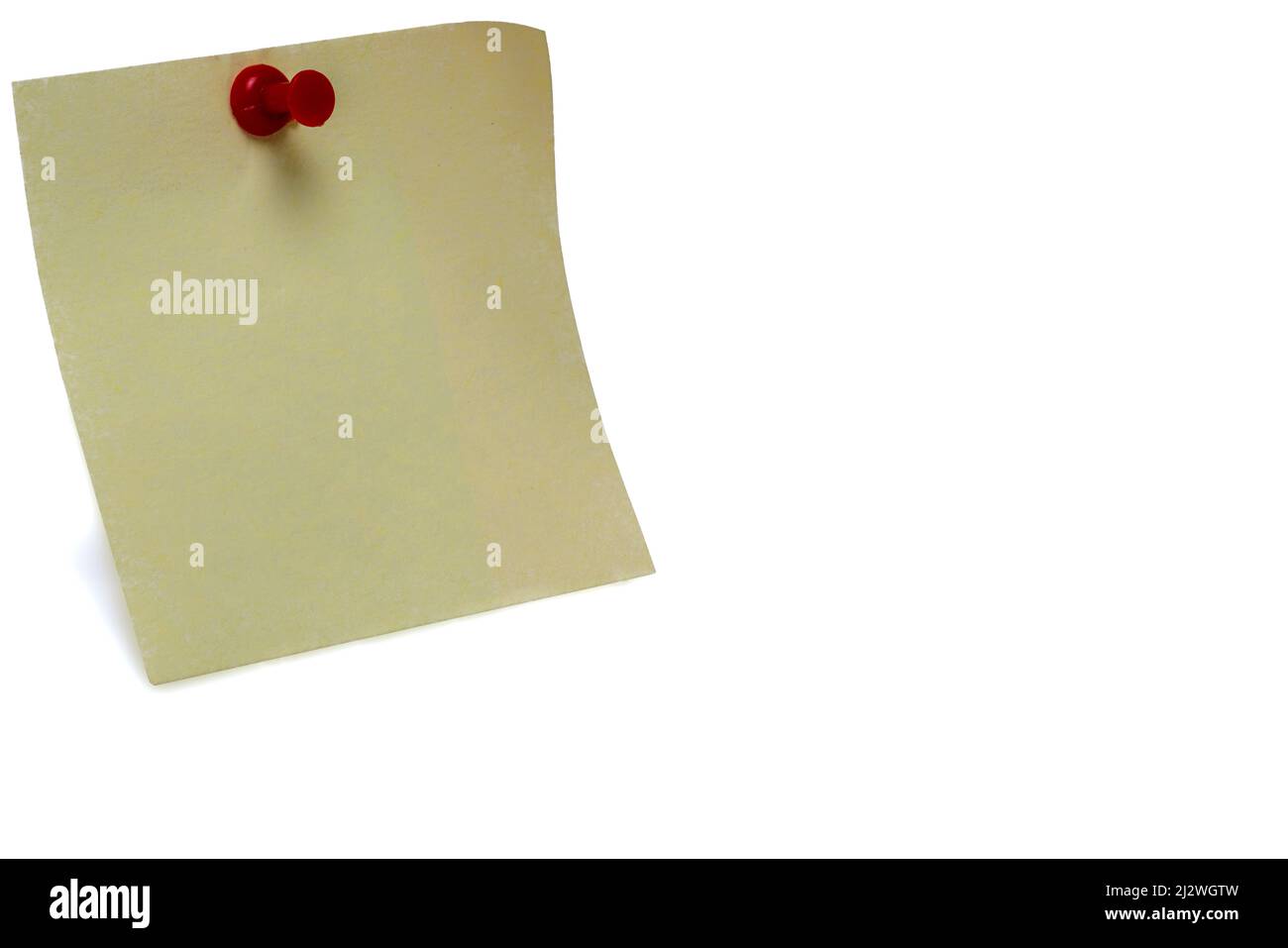 Close up of yellow postit note with red pin needle on white background ...