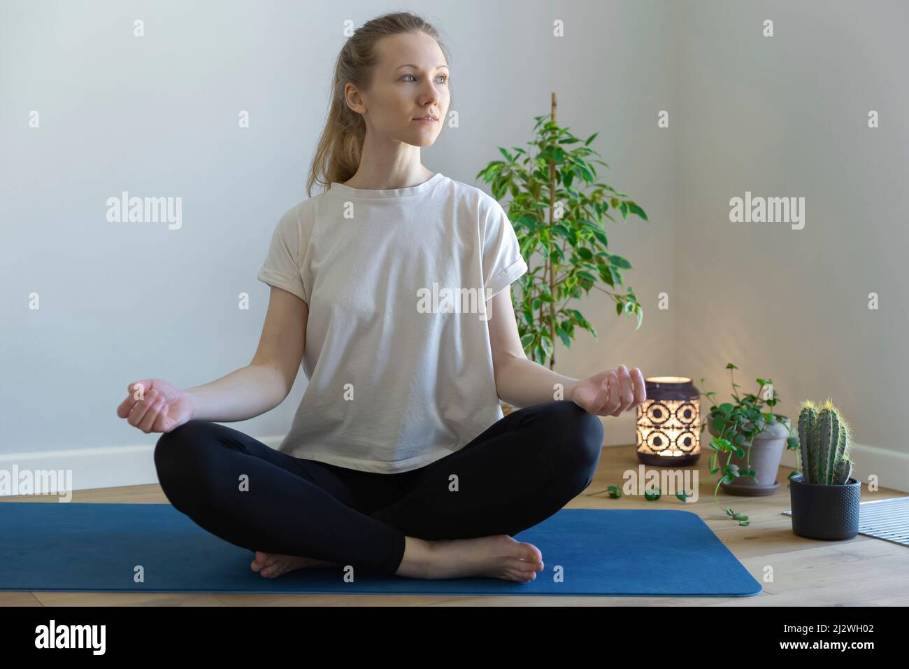 woman sitting cross-legged Stock Photo - Alamy