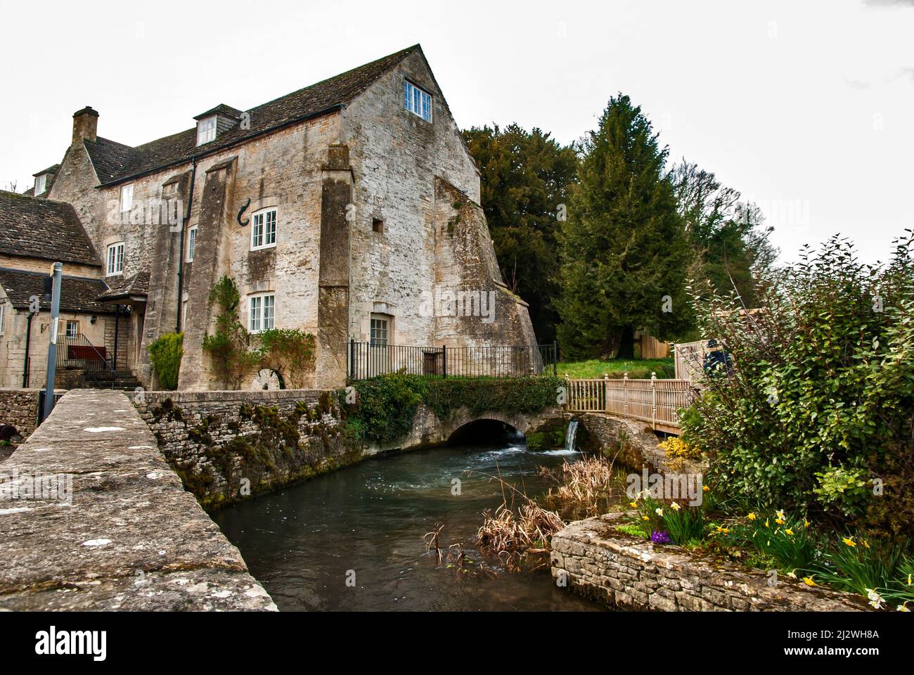 River passing old stone medieval houses in British provincial village ...